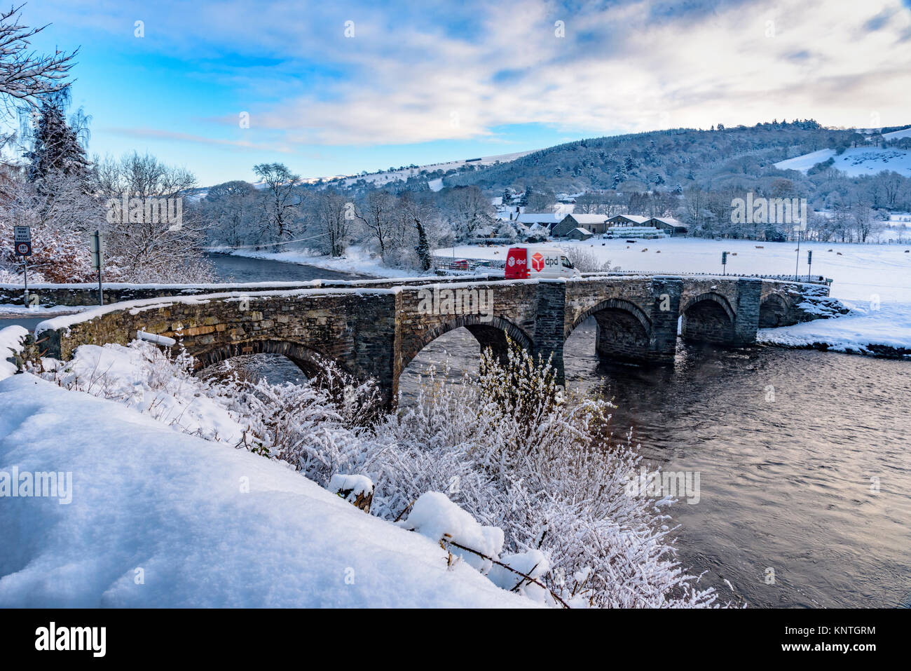 Snowy scene North Wales River Dee by the old stone bridge at Carrog ...