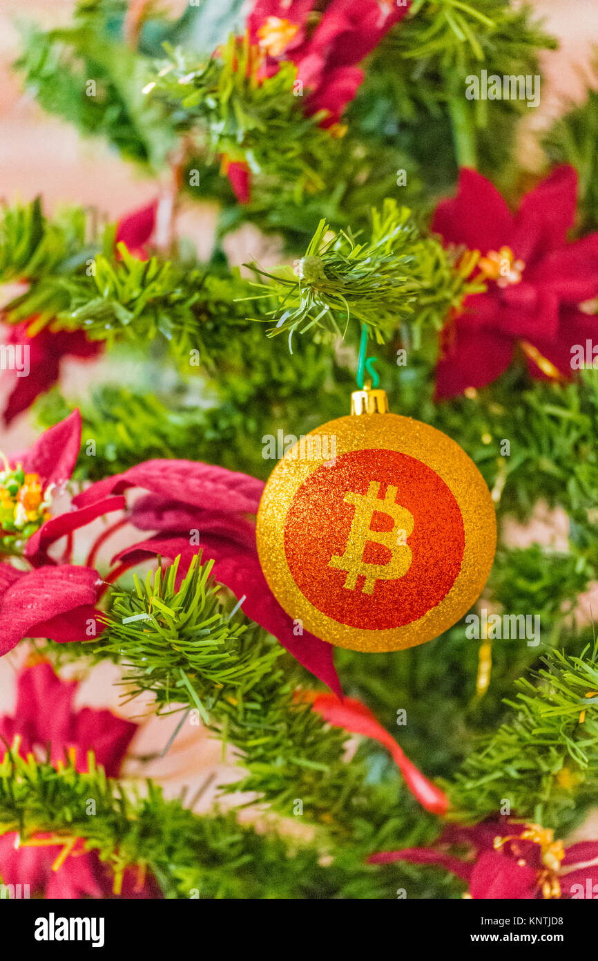 Christmas ball with bitcoin logo in red, yellow and orange decorations ...