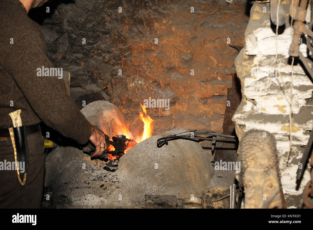 Blacksmith working in the forge processes the metal . The photograph on ...