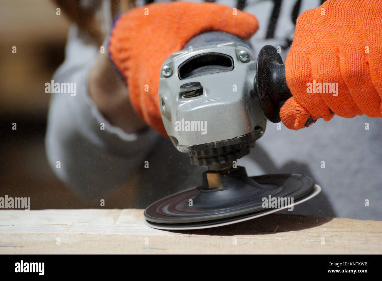 Worker grinds the wood of angular grinding machine Stock Photo - Alamy