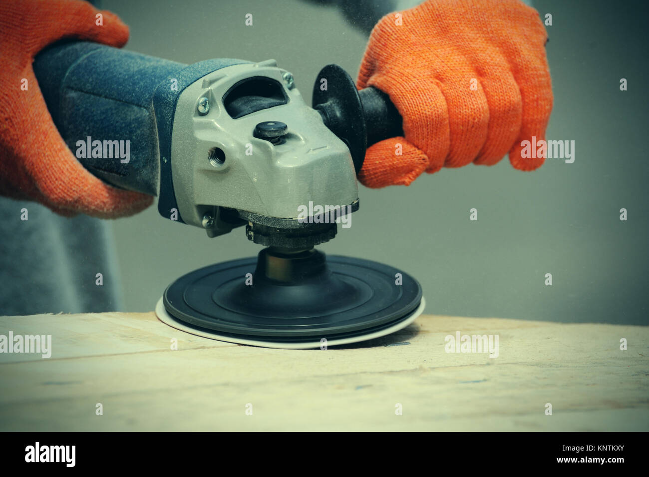 Worker grinds the wood of angular grinding machine Stock Photo - Alamy