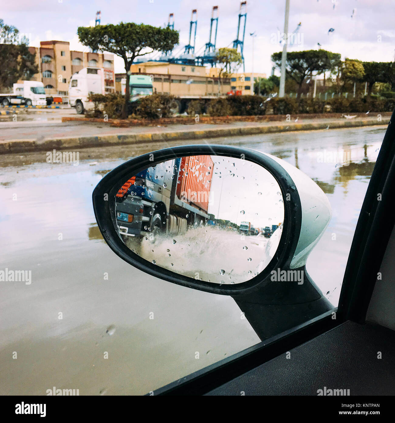 Fast truck splash water on car side window Stock Photo - Alamy