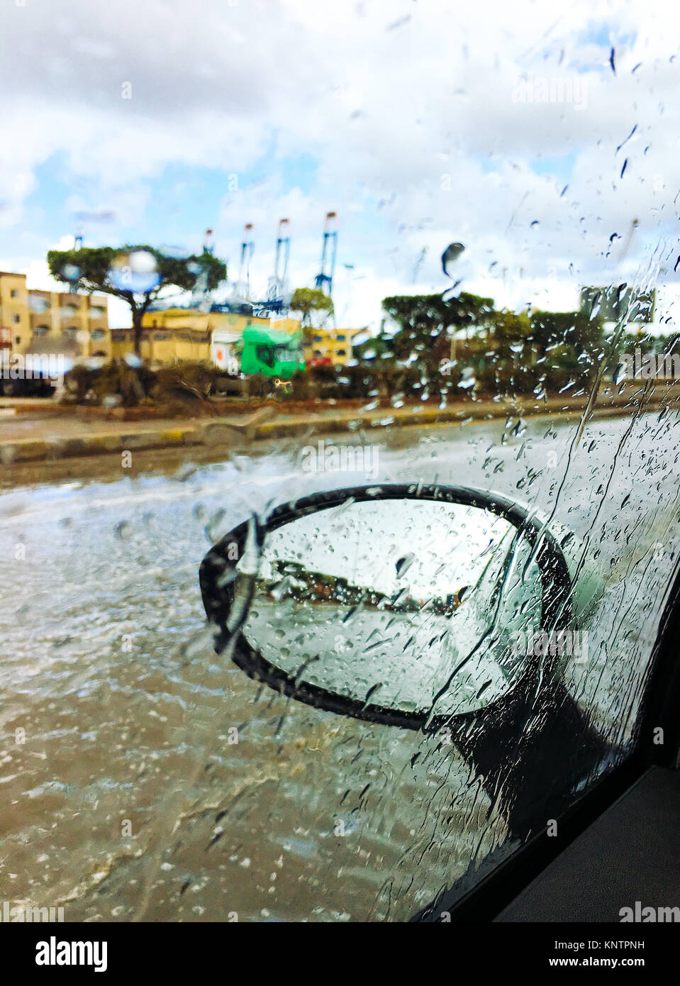 Rain streaked window with street view, rain water on road Stock Photo ...