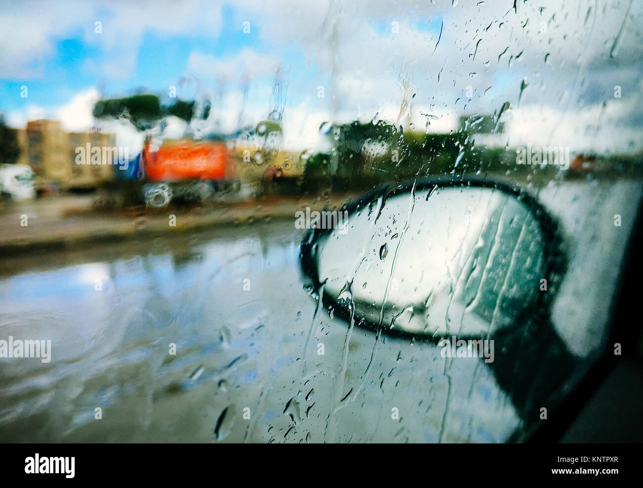 Rain streaked window with street view, rain water on road Stock Photo ...