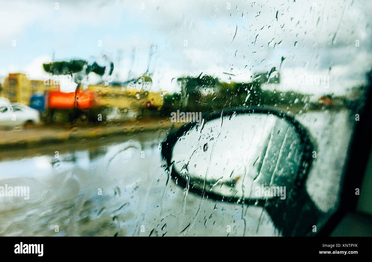 Rain streaked window with street view, rain water on road Stock Photo ...