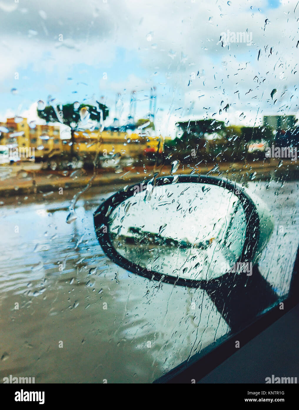 Rain streaked window with street view, rain water on road Stock Photo ...