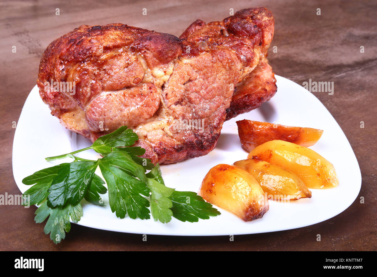 Juicy pork neck chops are grilled with potatoes on a white plate Stock ...