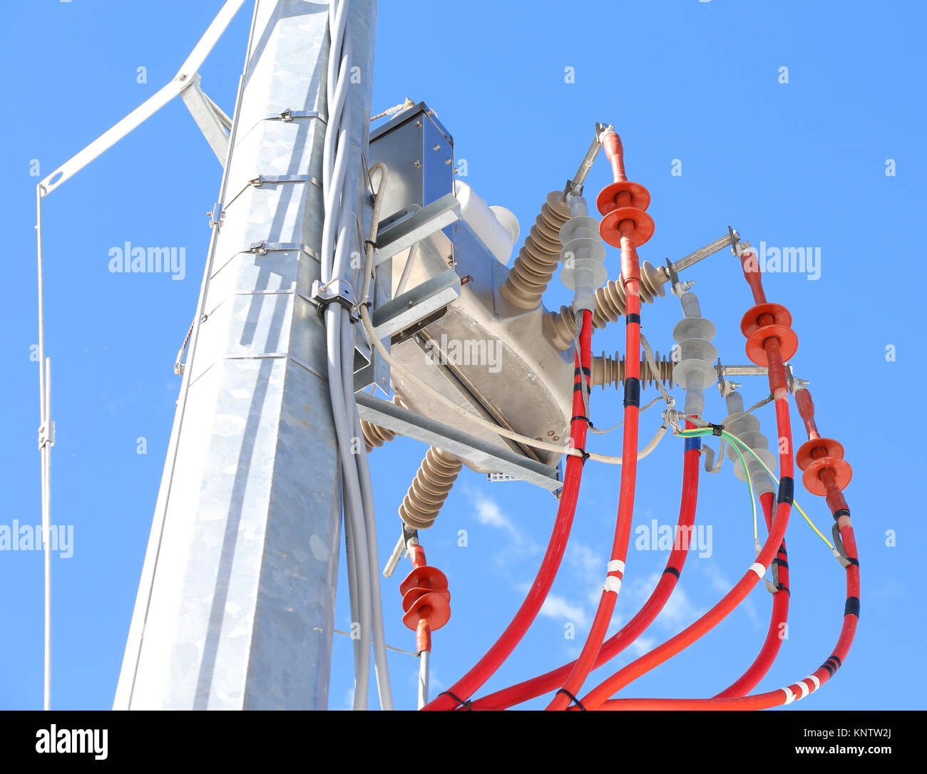 electric transformer and red high voltage electrical cables and blue ...