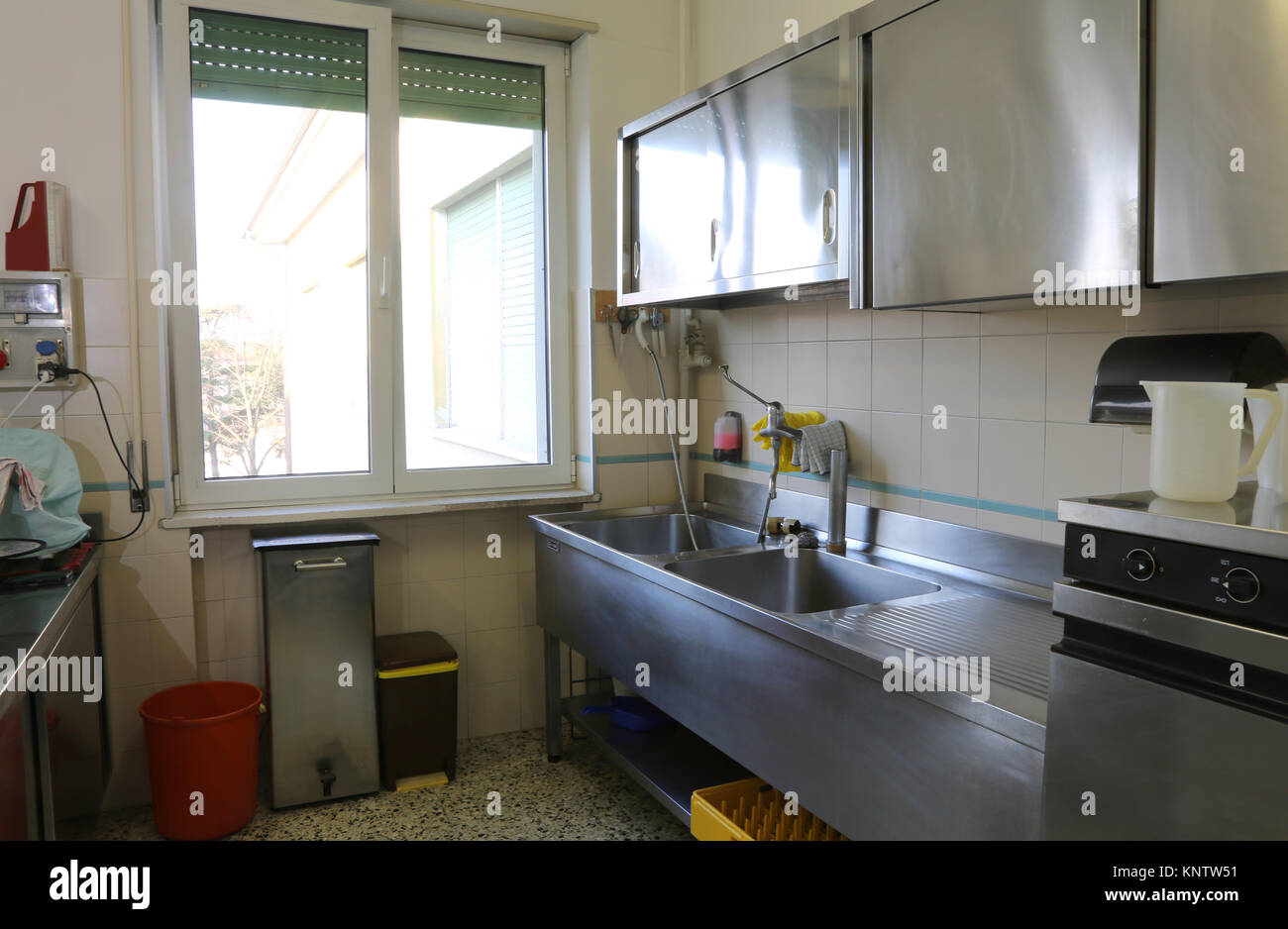 inside a Commercial Industrial Kitchen with furniture in stain steel ...