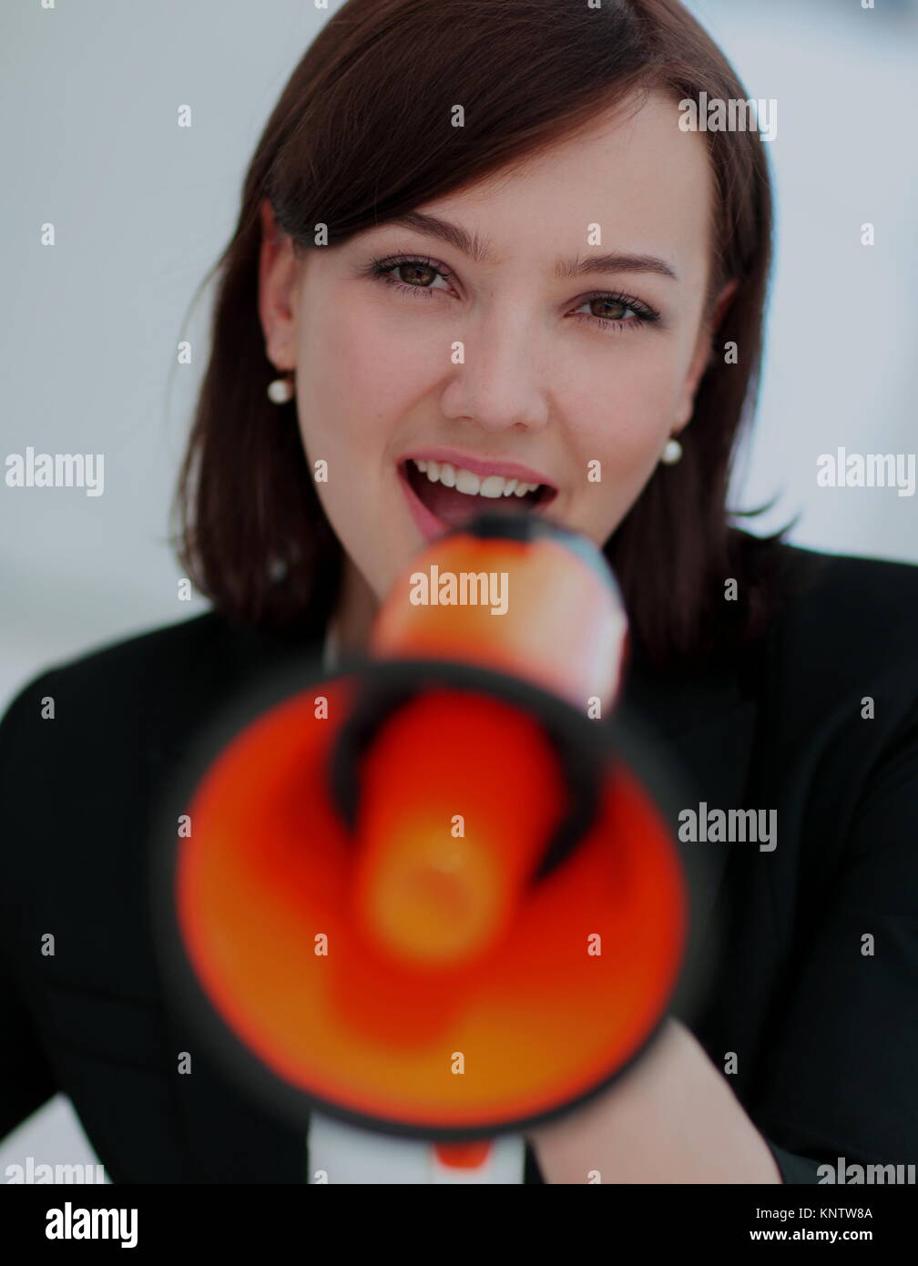 Beautiful business woman using a megaphone to scream Stock Photo - Alamy