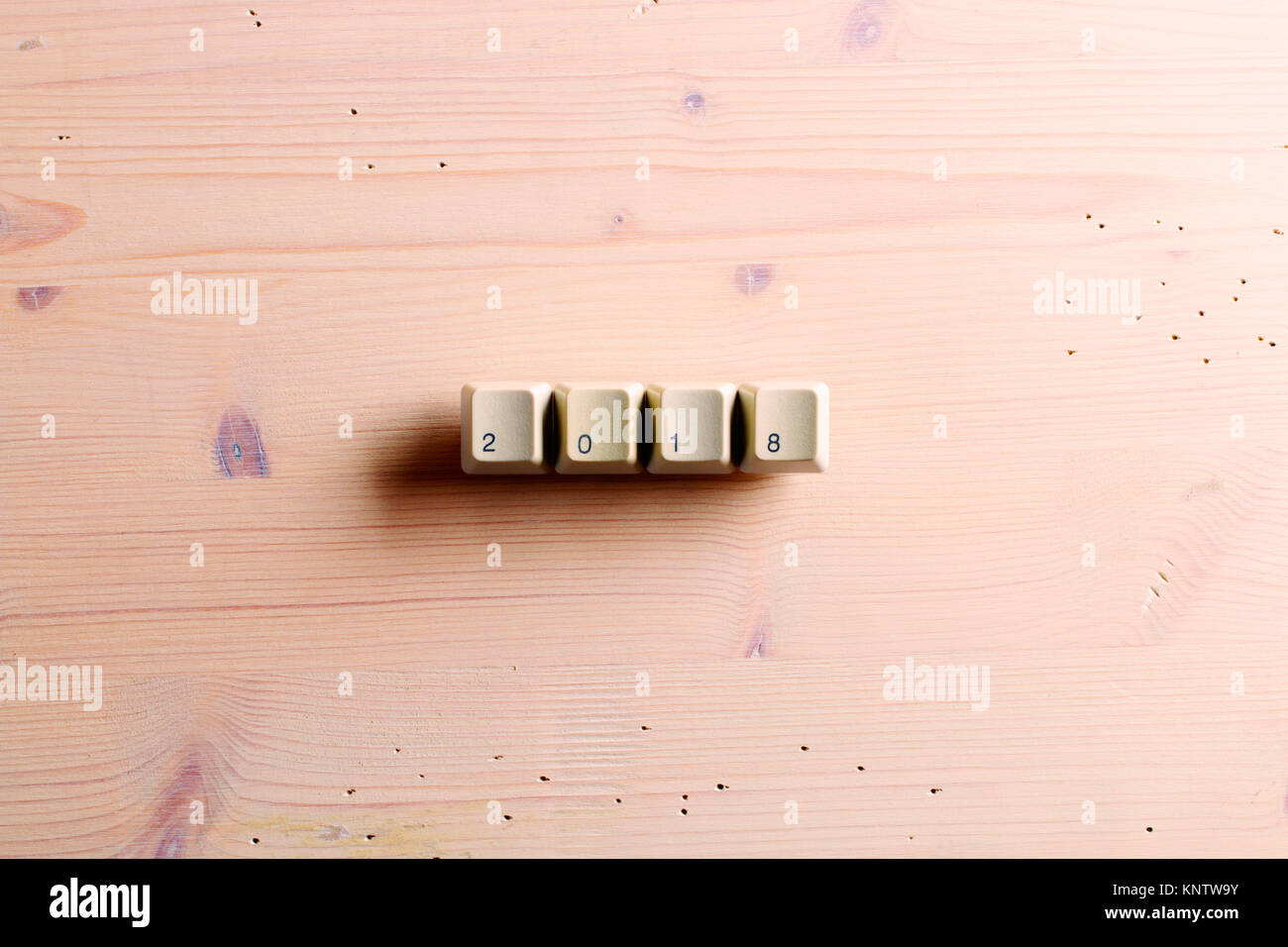 2018 word. Flat lay view from above on the table with computer keyboard keys buttons on a wooden ...