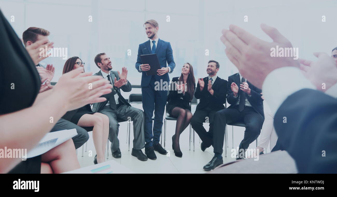 Business group greets leader with clapping and smiling Stock Photo - Alamy