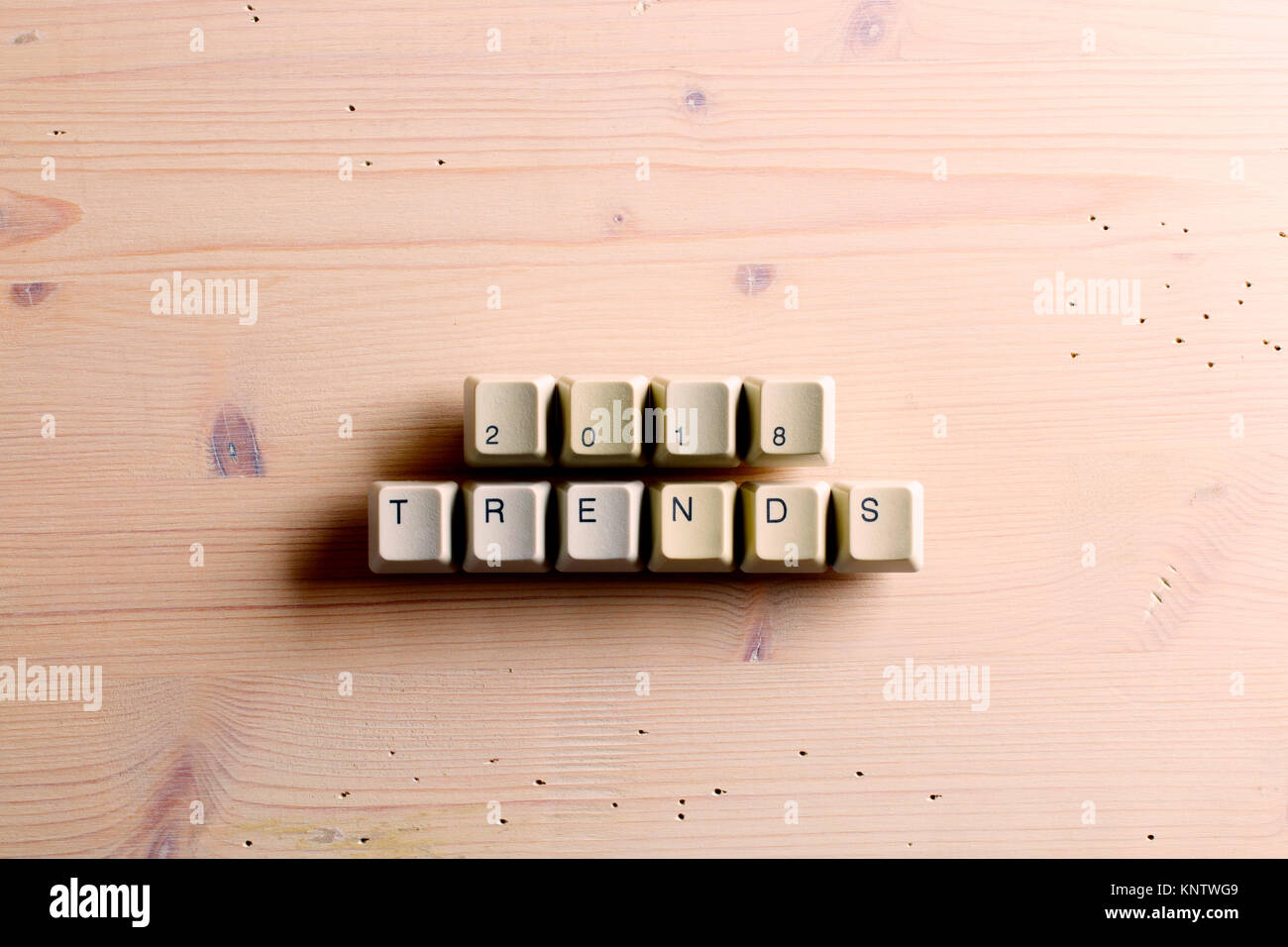 Trends 2018. Flat lay view from above on the table with computer keyboard keys buttons on a ...