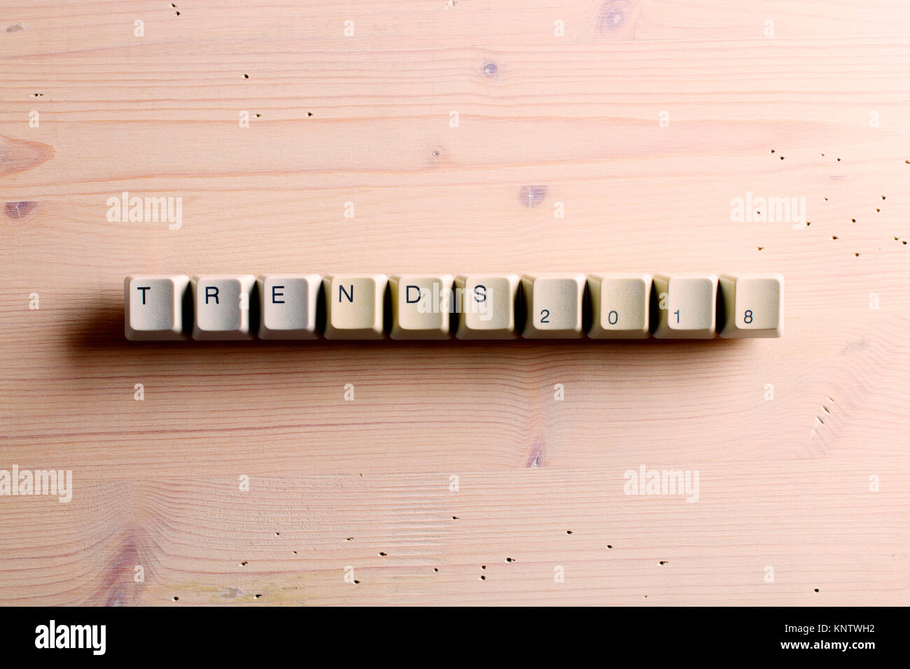 Trends 2018. Flat lay view from above on the table with computer keyboard keys buttons on a ...
