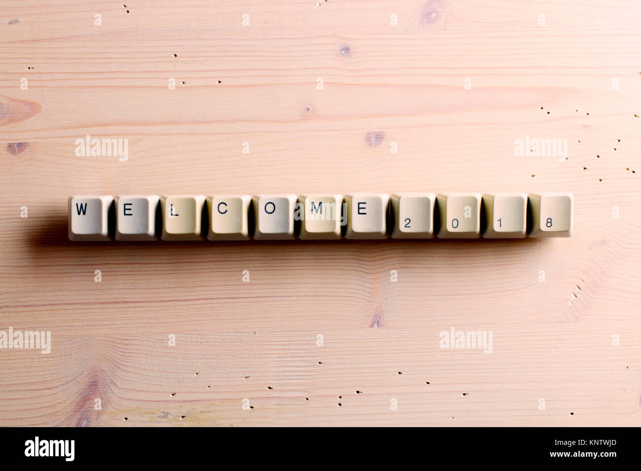 Welcome 2018 New Year. Flat lay view from above on the table with computer keyboard keys buttons ...
