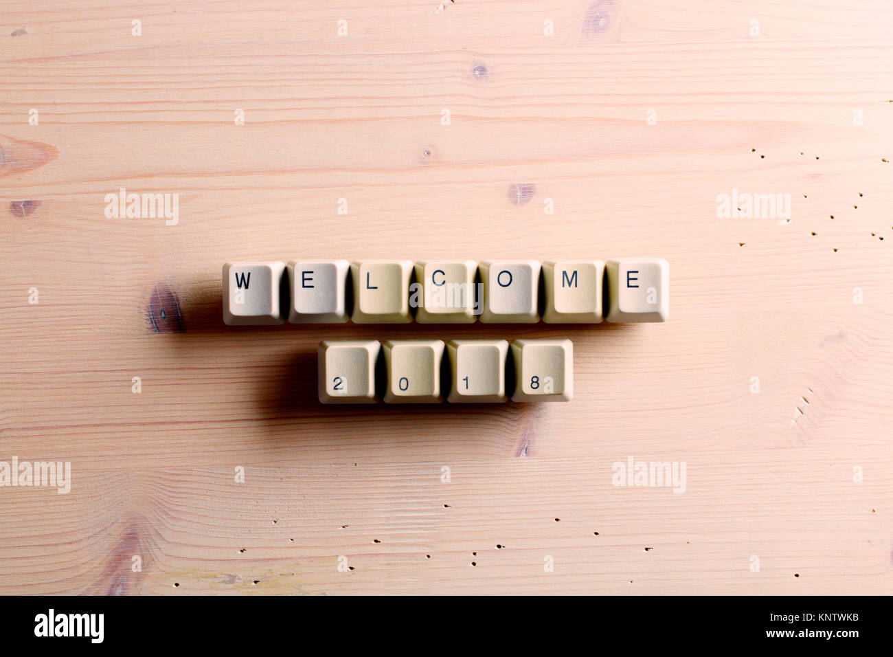 Welcome 2018 New Year. Flat lay view from above on the table with computer keyboard keys buttons ...