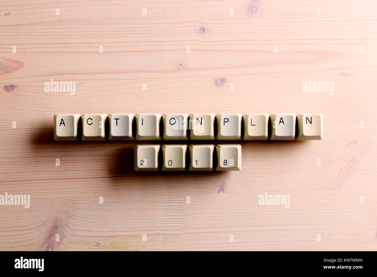 Action plan 2018. Flat lay view from above on the table with computer keyboard keys buttons on a ...