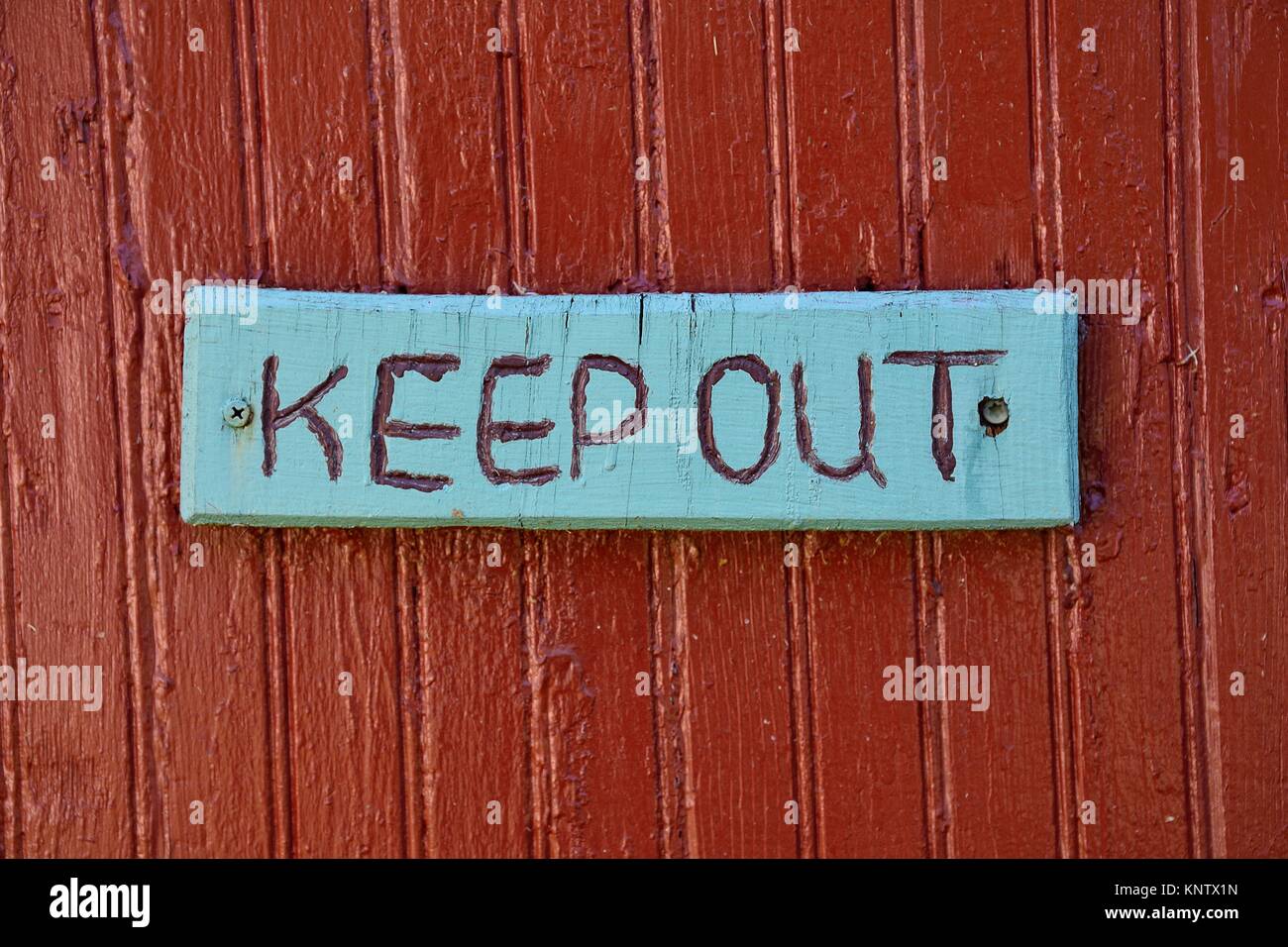 Keep out warning sign over old rustic wooden textured surface Stock ...