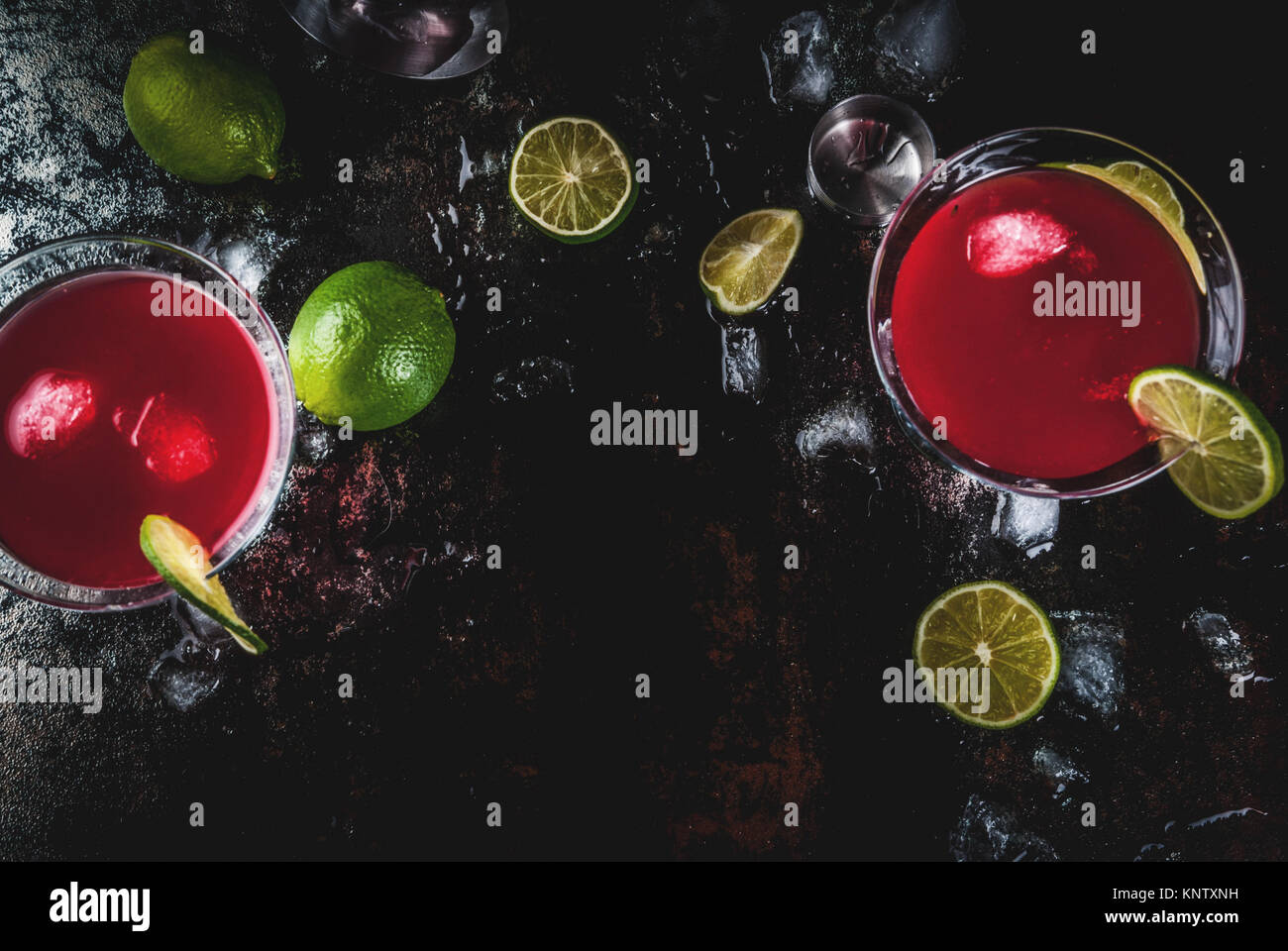 Red cosmopolitan cocktail with lime in martini glass, on dark rusty ...