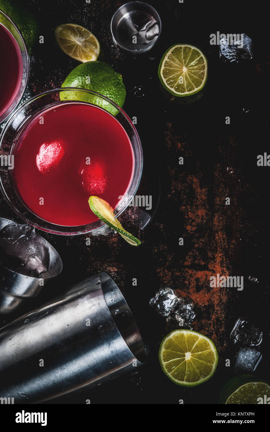 Red cosmopolitan cocktail with lime in martini glass, on dark rusty ...