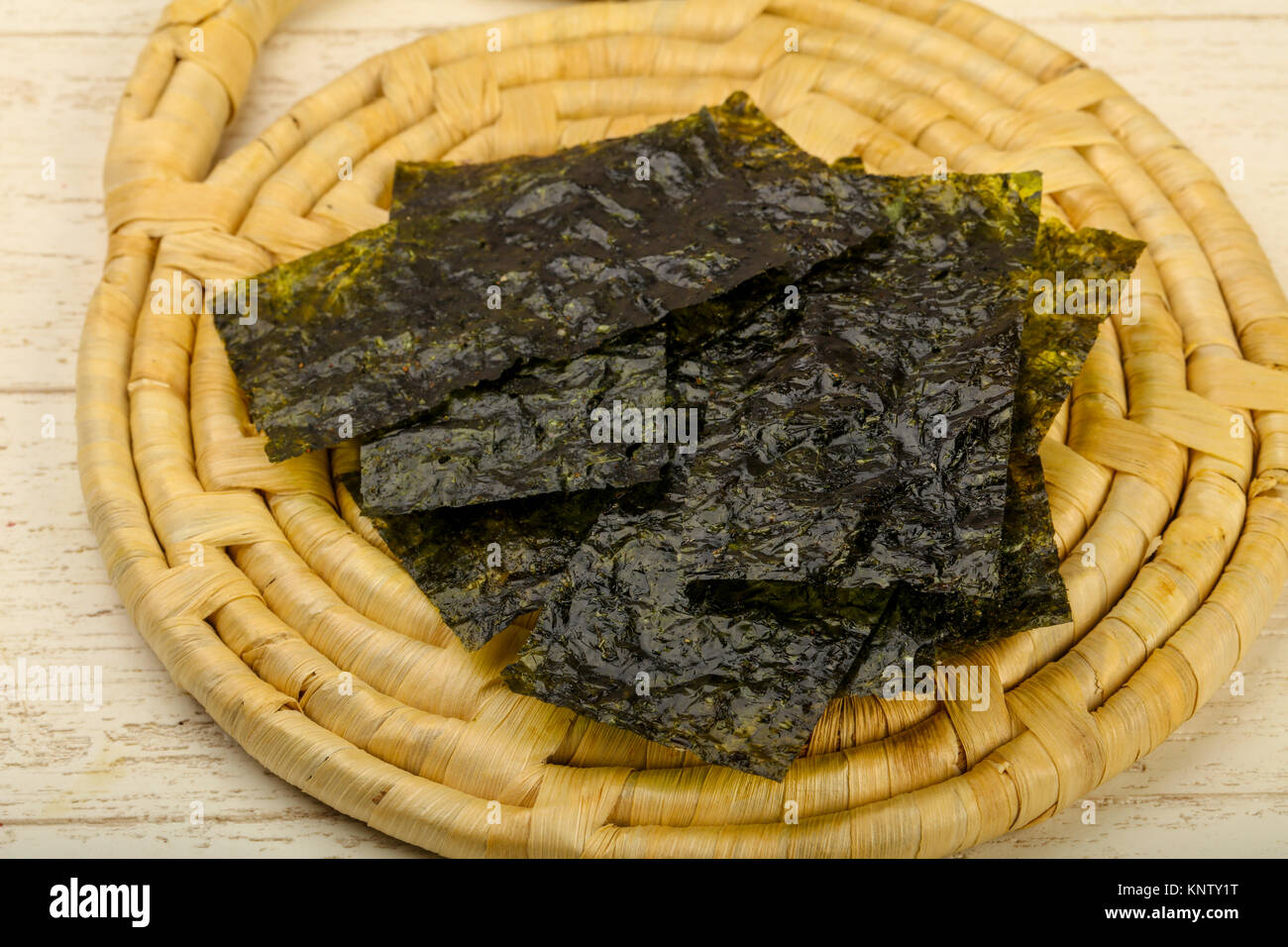 Crispy Nori sheets chips over wooden background Stock Photo - Alamy