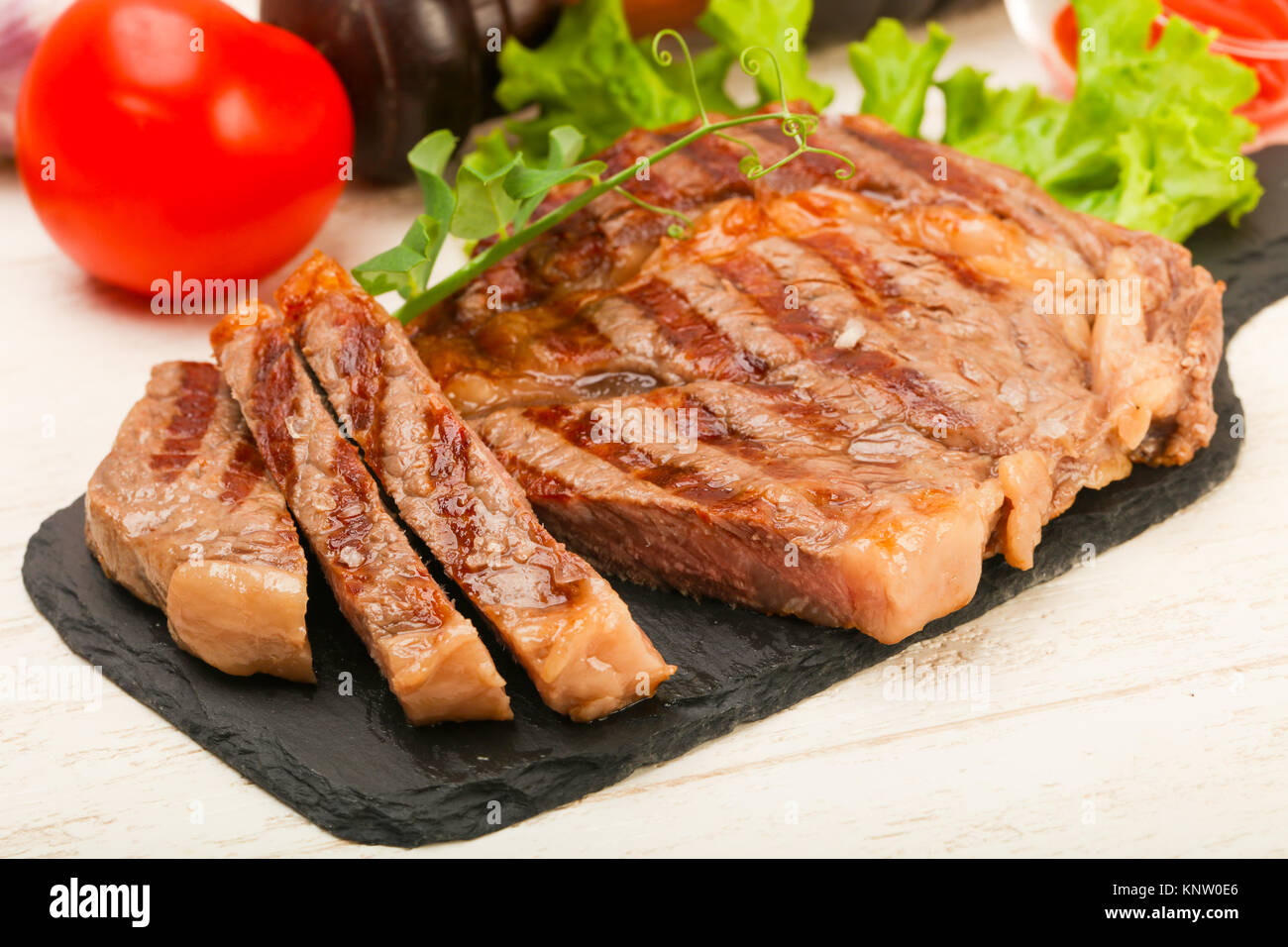 Grilled Rib eye steak with sauce Stock Photo - Alamy
