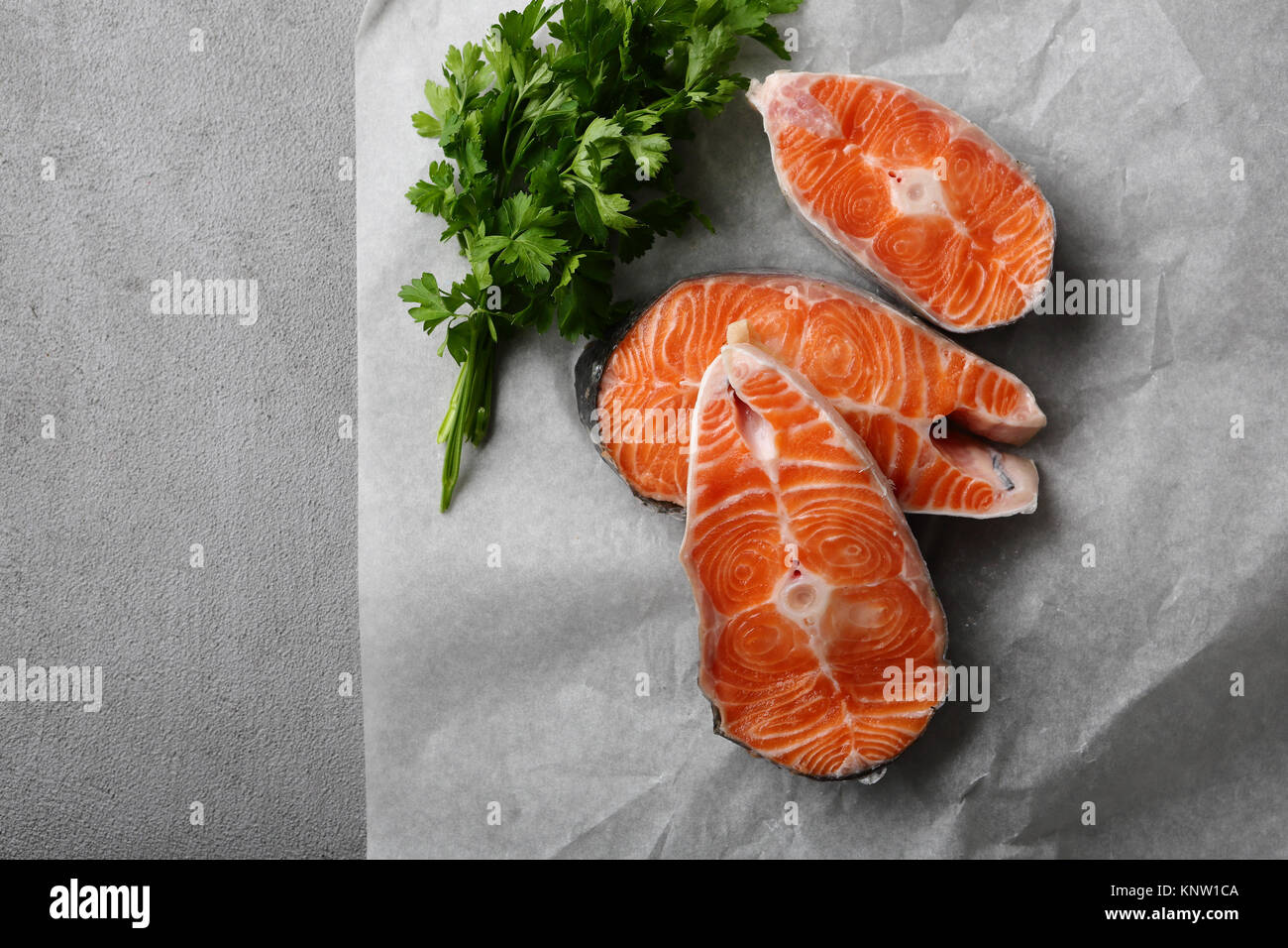 Three salmon steaks on concrete, food above Stock Photo - Alamy