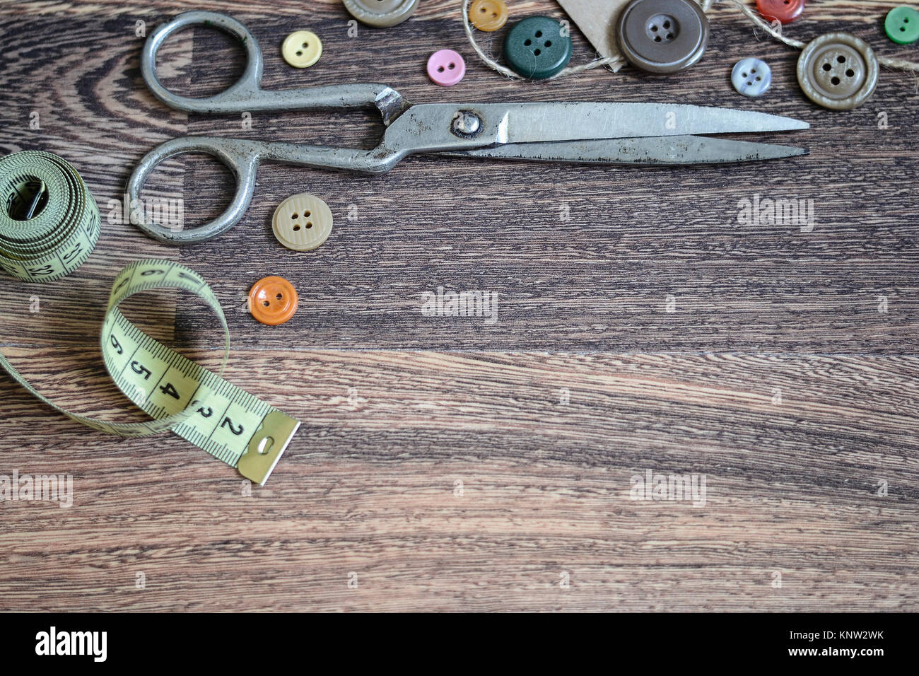 Scissors and buttons on a wooden background for embroidery Stock Photo ...