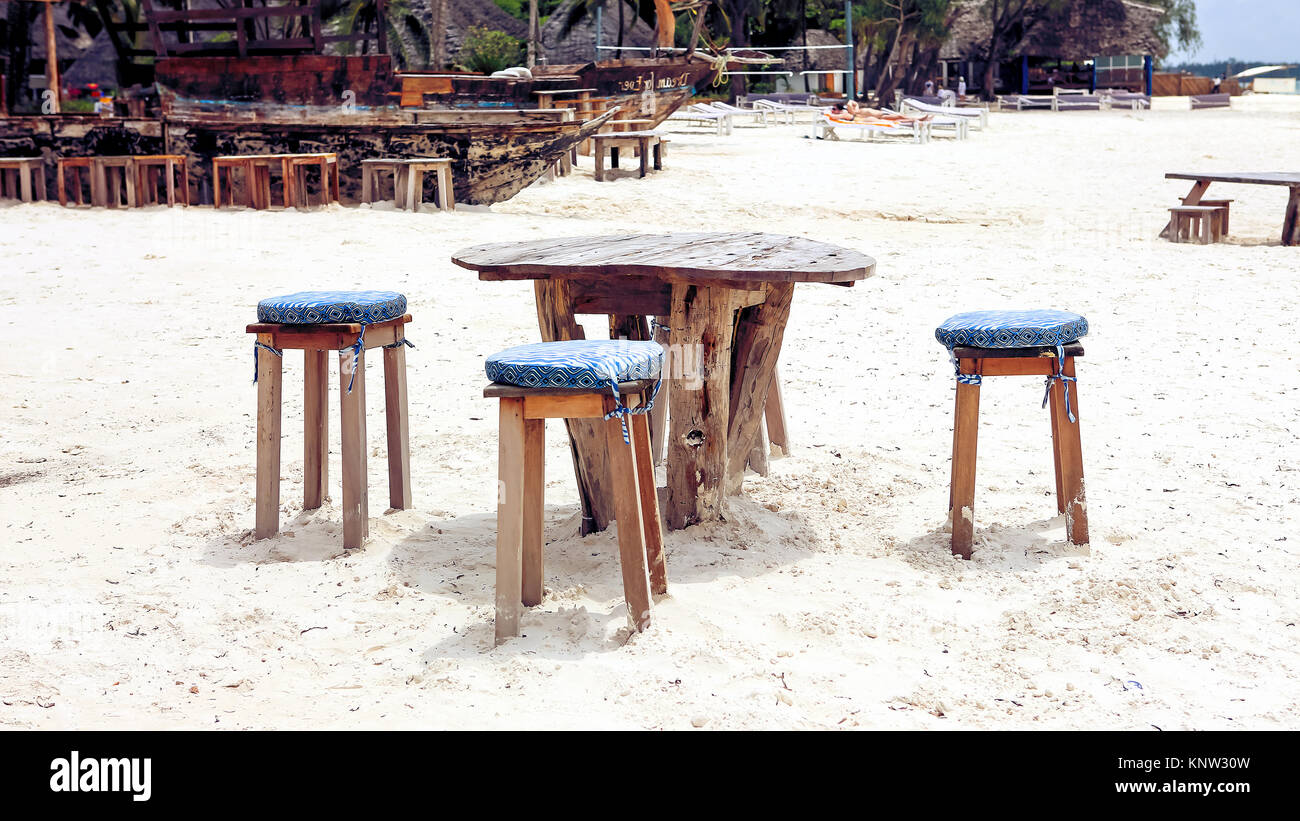 Wooden table and chairs on the beach Stock Photo - Alamy