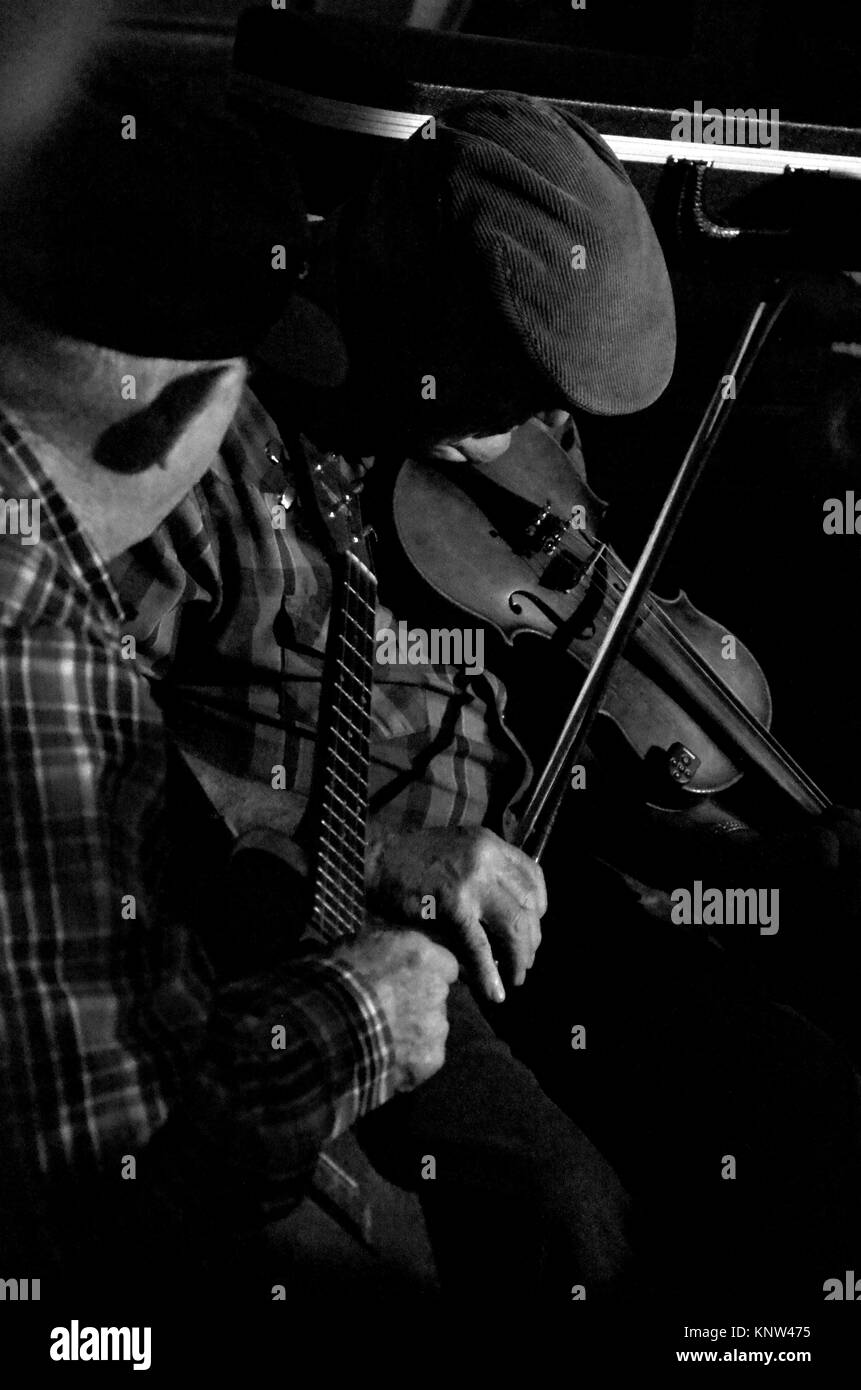 Monochrome photo of musicians playing outside in the street at the ...