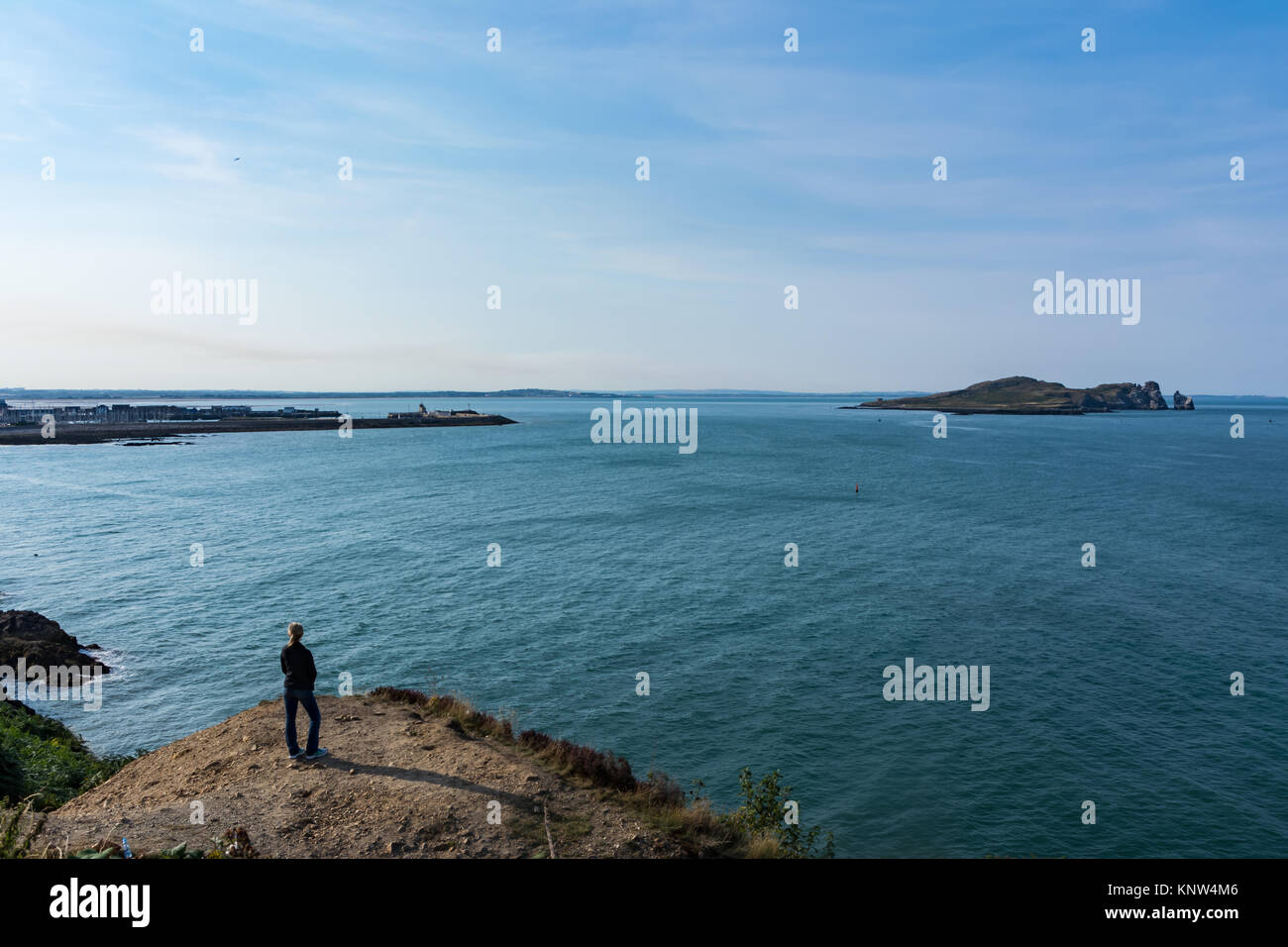 Woman On Cliff Howth Harbor Ireland Ocean Human Small Perspective Stock ...
