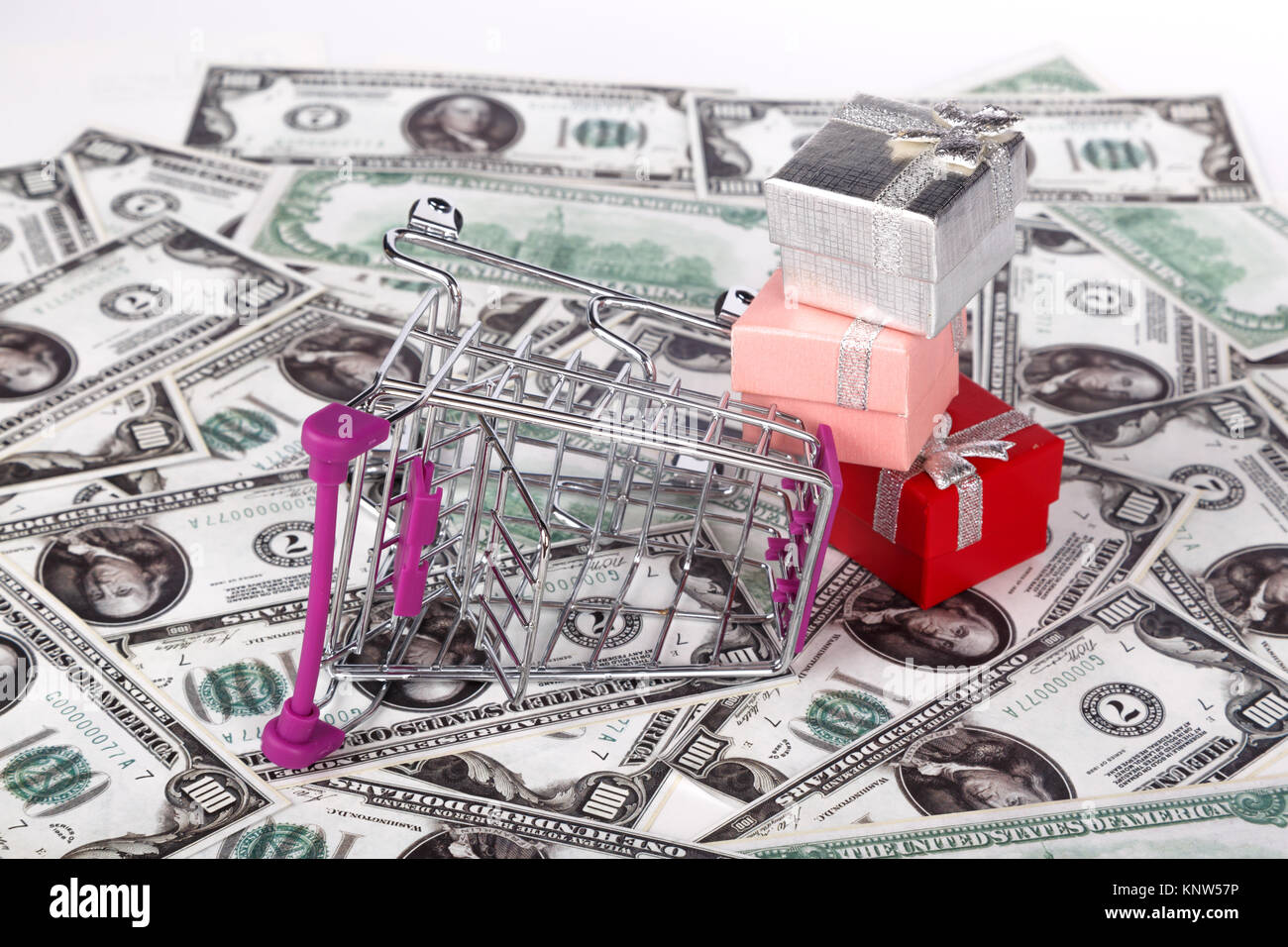 Stack of Dollar banknotes with shopping cart and gift boxes in money ...