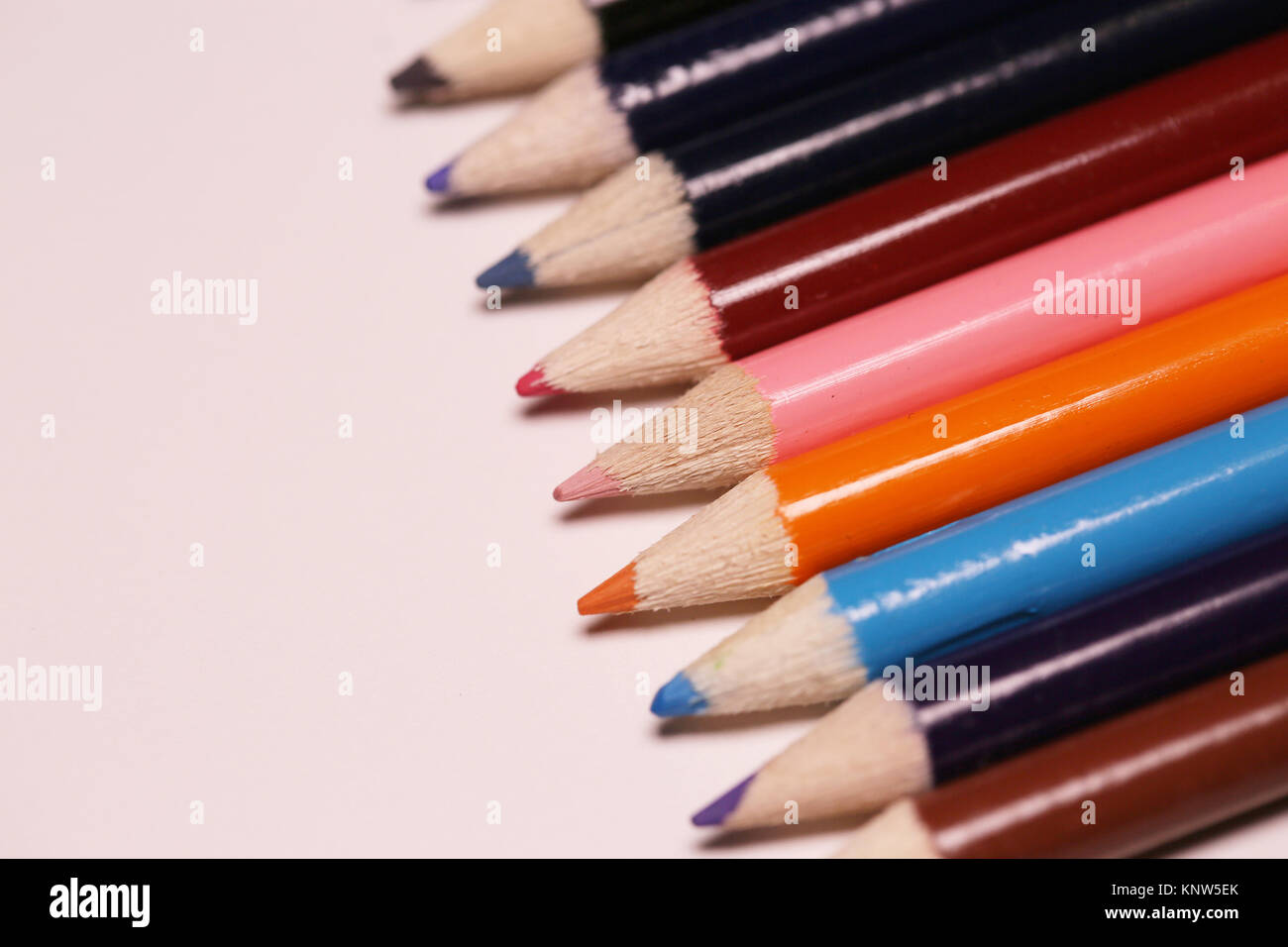 Multicolored pencils on the table. A stack of colored pencils tied ...