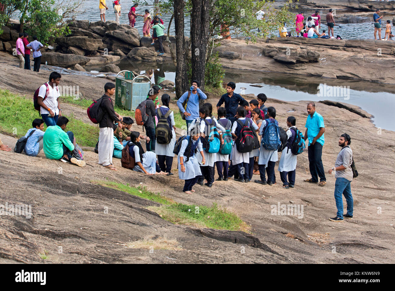 school kids with school bag on a study tour at athirapilly water falls ...