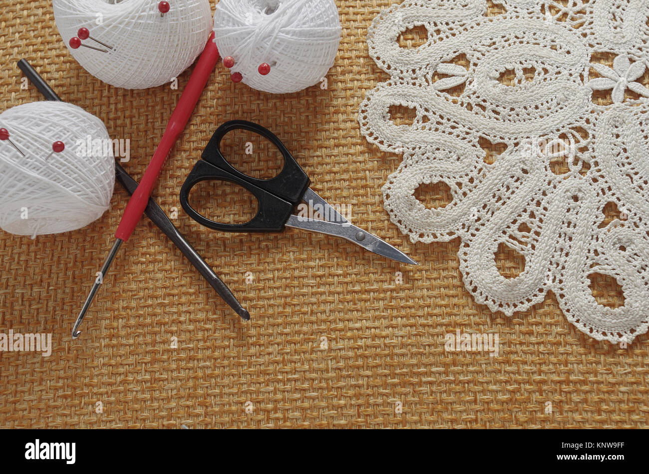 Objects for sewing. Scissors and pins. Hanks thread on mat. Pins and ...