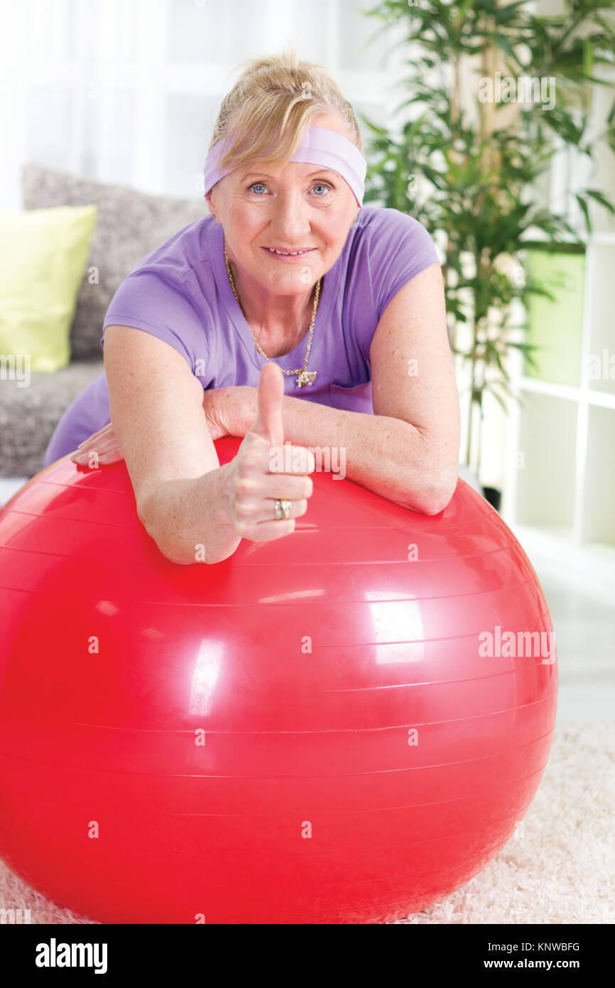 Senior woman after exercises shoving thumb up Stock Photo - Alamy