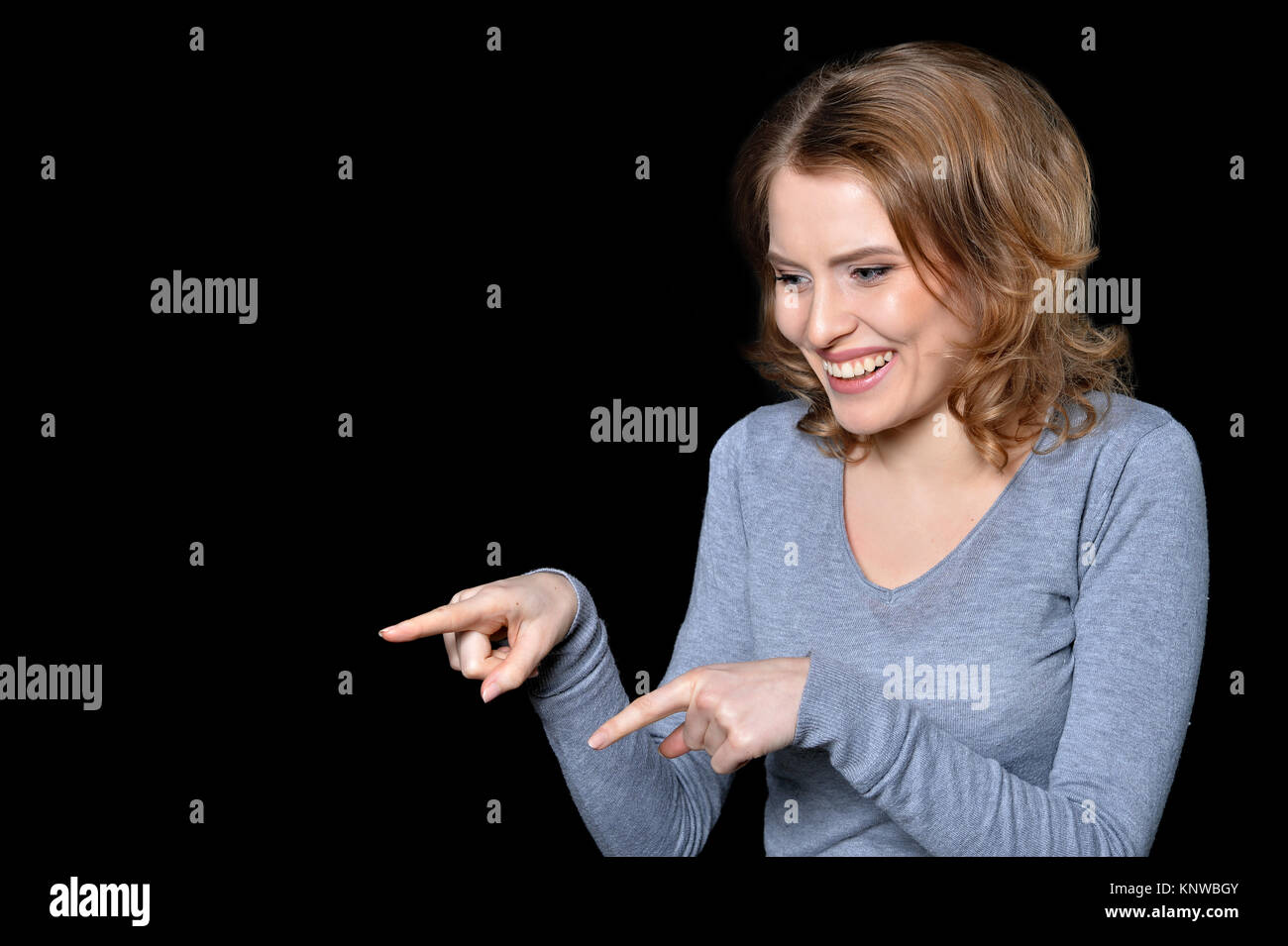 young woman showing something Stock Photo - Alamy
