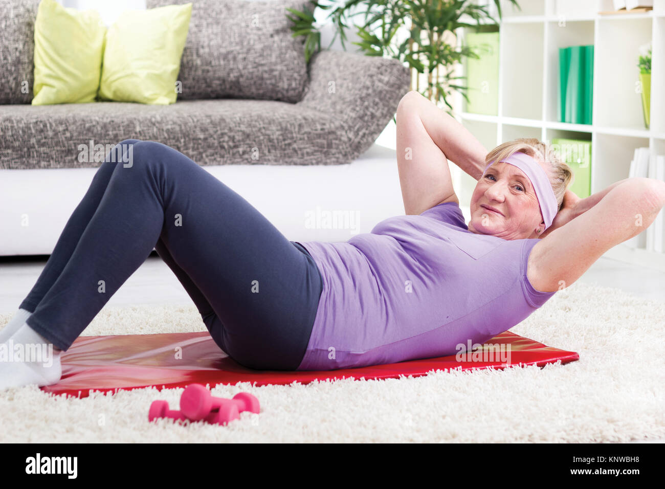 Senior woman exercising at home Stock Photo - Alamy