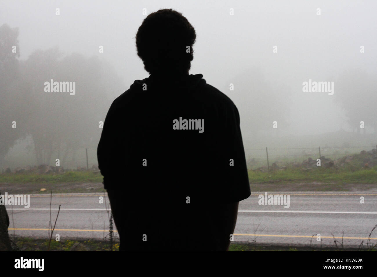 A man in the dark and the fog Stock Photo - Alamy