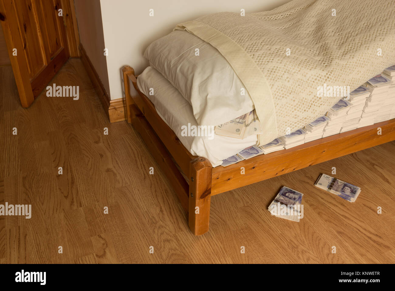 A ready supply of stashed cash money banknotes under the bed mattress ...