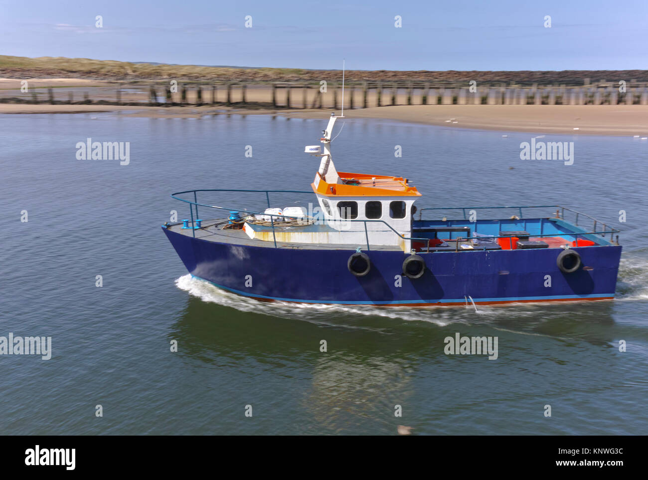 A fishing boat returning to Amble harbour in Northumberland,after a ...