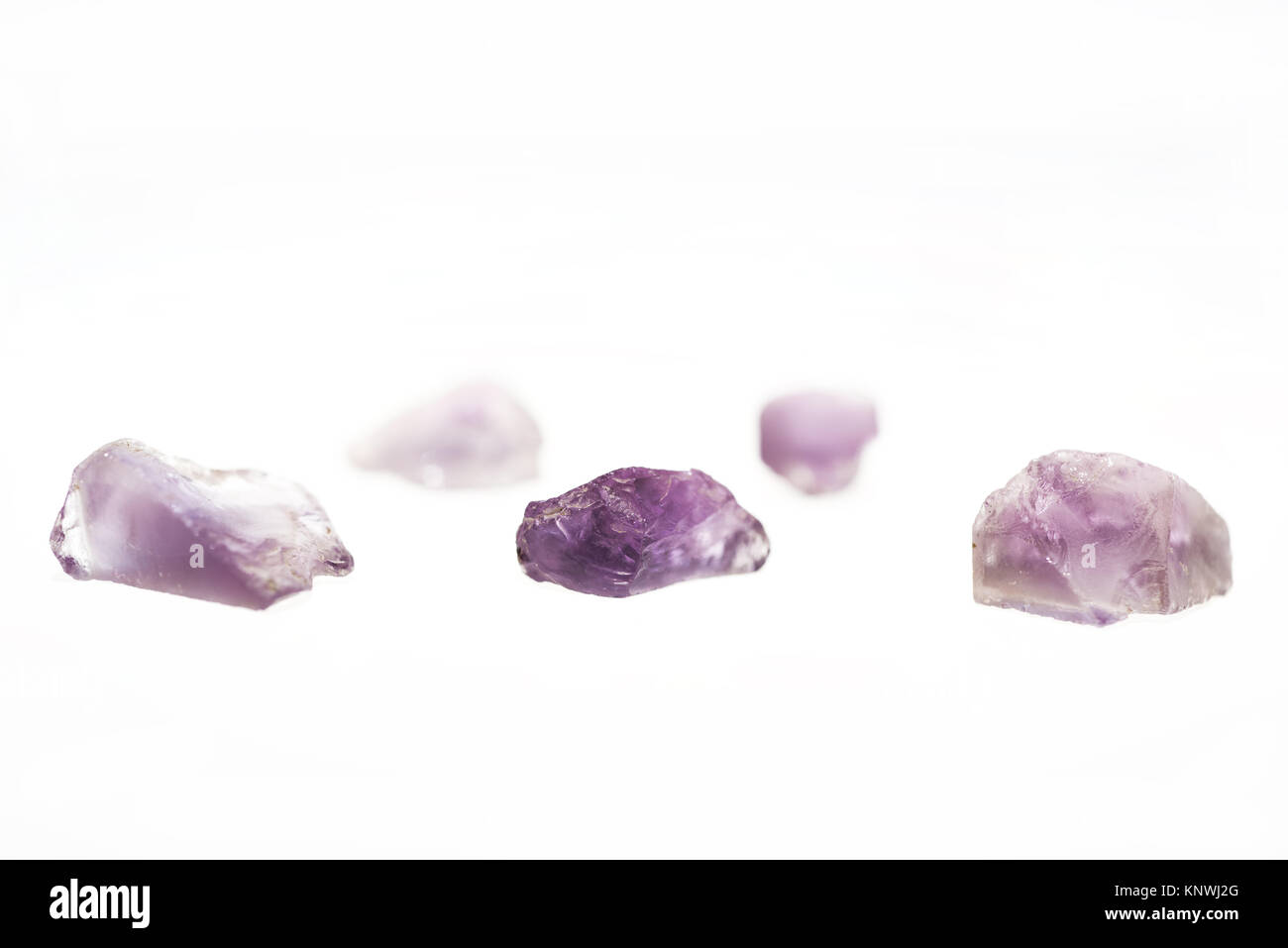 Amethyst small stones. Gems isolated on white background Stock Photo ...