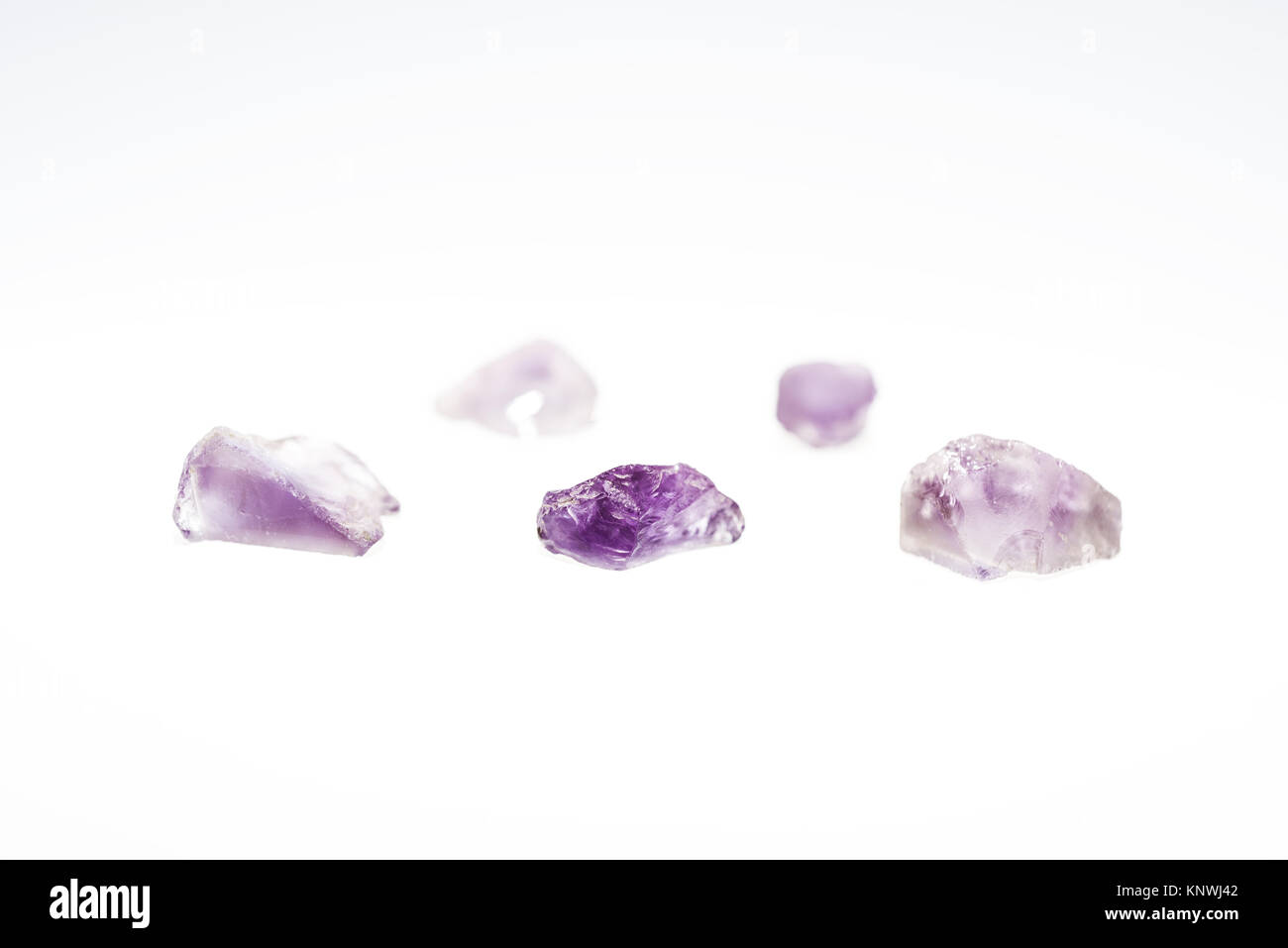 Amethyst small stones. Gems isolated on white background Stock Photo ...