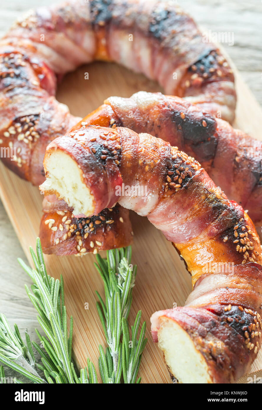 Bagels with sesame wrapped in bacon rashers Stock Photo - Alamy