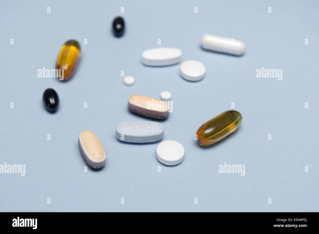 Prescription drugs isolated on a blue background, assorted tablets ...