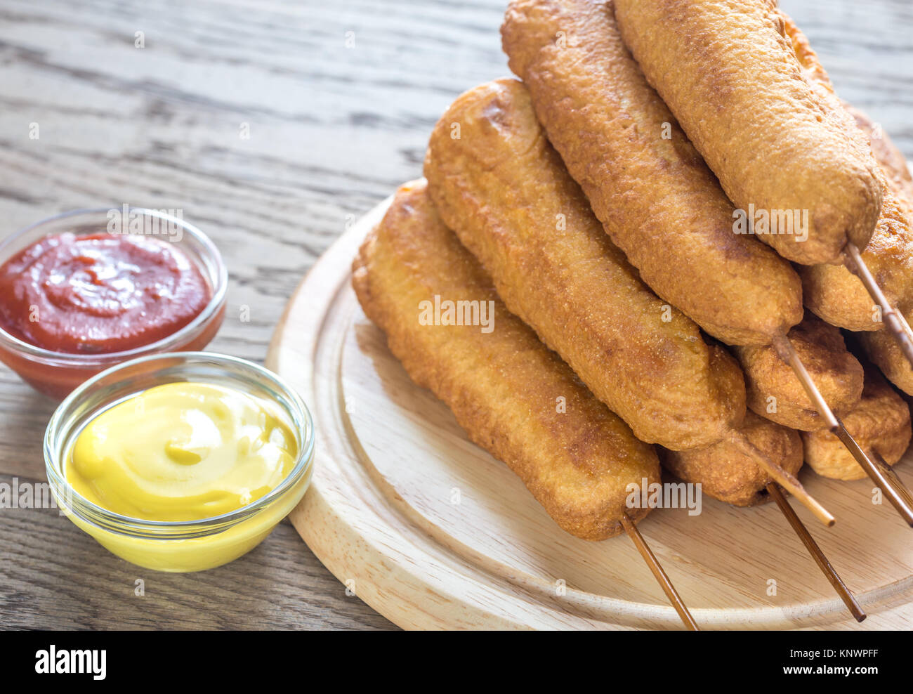 Stack of corn dogs on the wooden board Stock Photo - Alamy