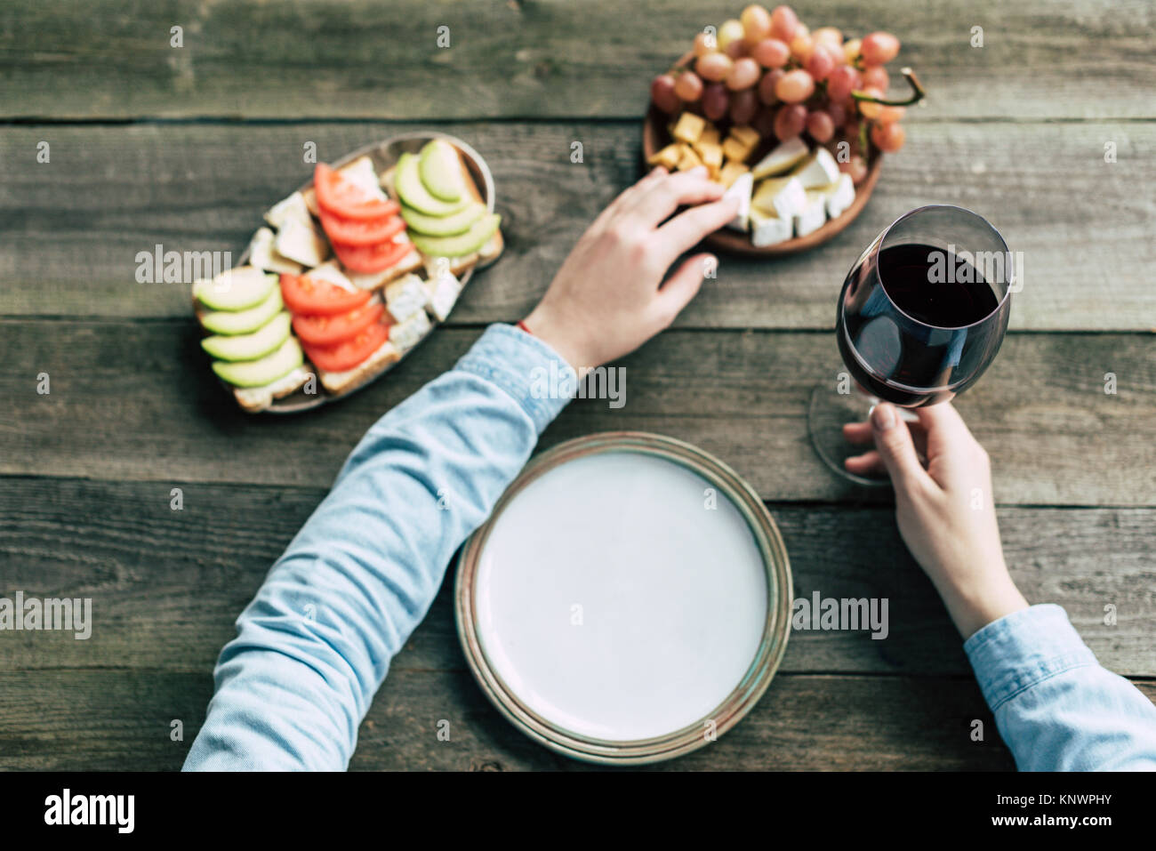 Woman taking cheese Stock Photo - Alamy