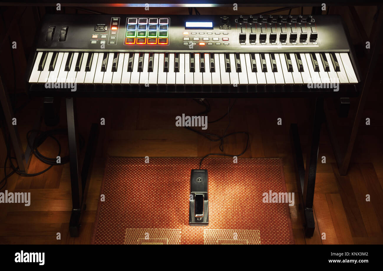 Details of modern midi keyboard in small home studio Stock Photo - Alamy