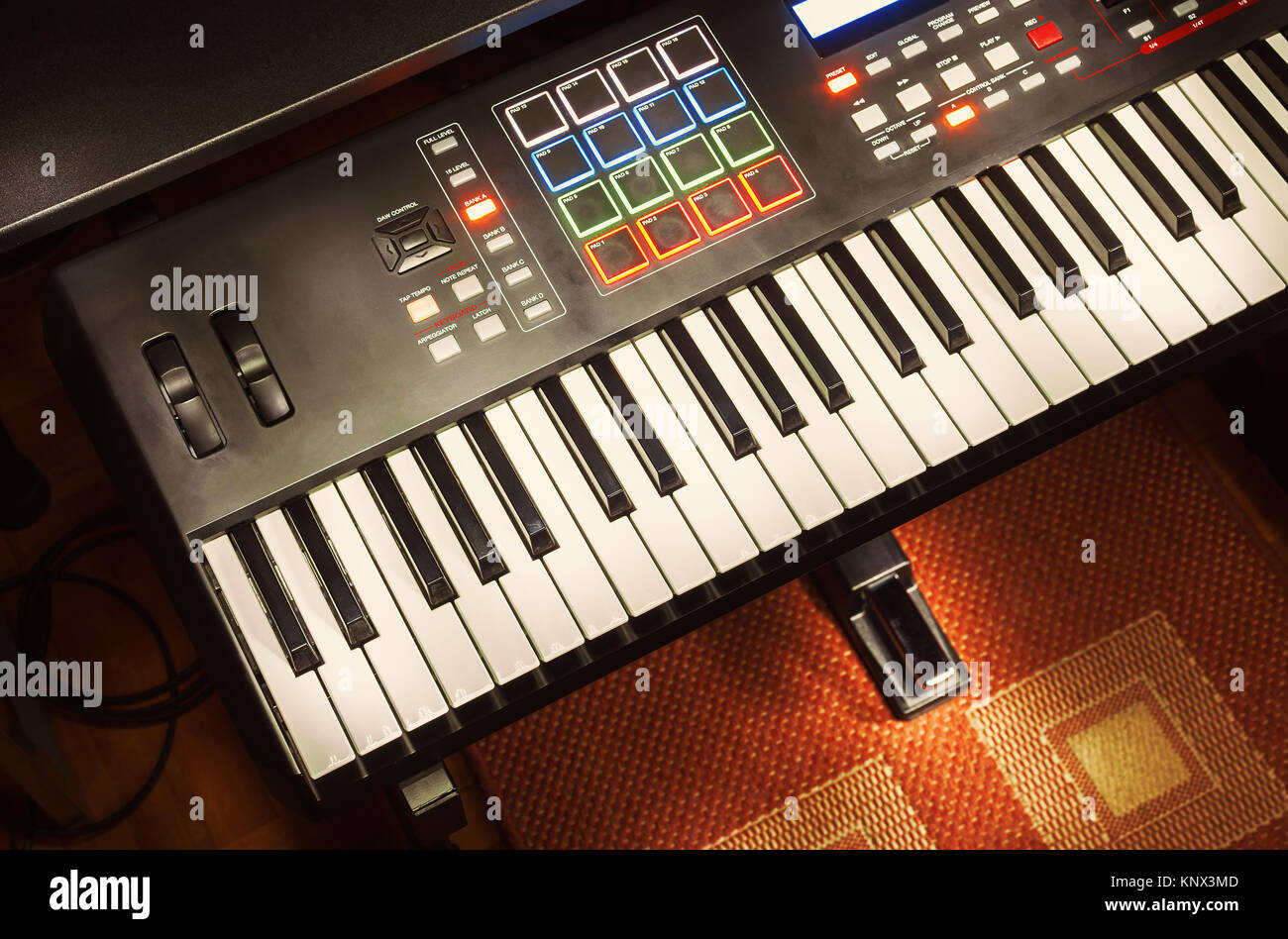 Details of modern midi keyboard in small home studio Stock Photo - Alamy