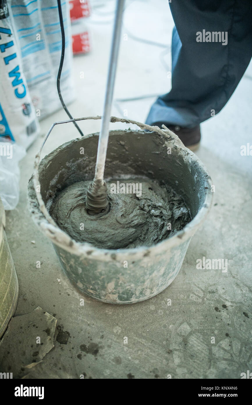 Mixing of a plaster solution by an electric drill. Home renovation ...